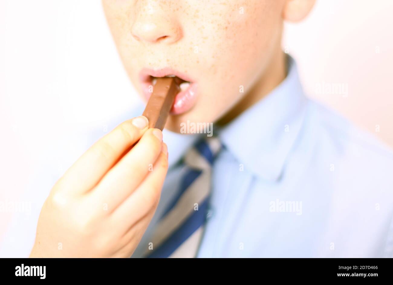 Child eating Quality Street Toffee Finger chocolate sweet, close up ...