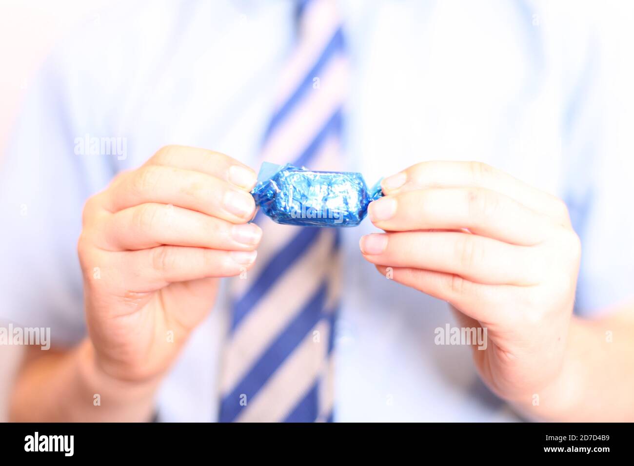 Boy unwrapping quality street hi-res stock photography and images - Alamy