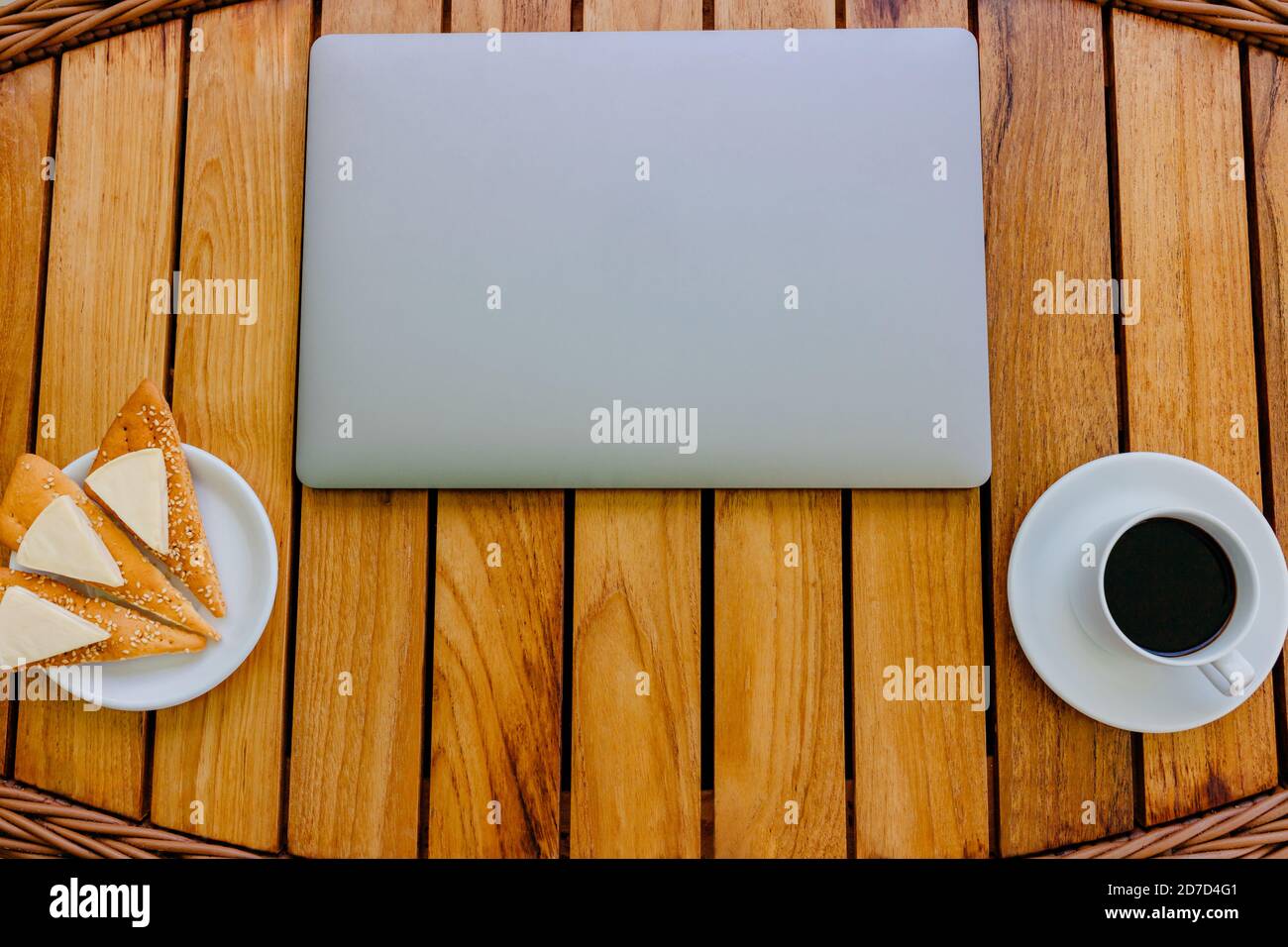 Break concept. Flat lay view of a workspace with a closed laptop with a ...