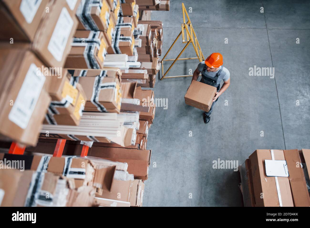 Top view of male worker in warehouse with box in hands Stock Photo - Alamy