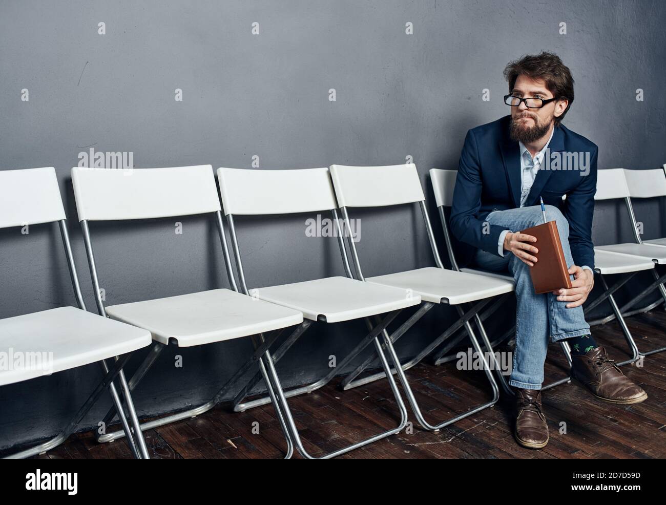 Man sitting on a chair one waiting job interview job Stock Photo - Alamy