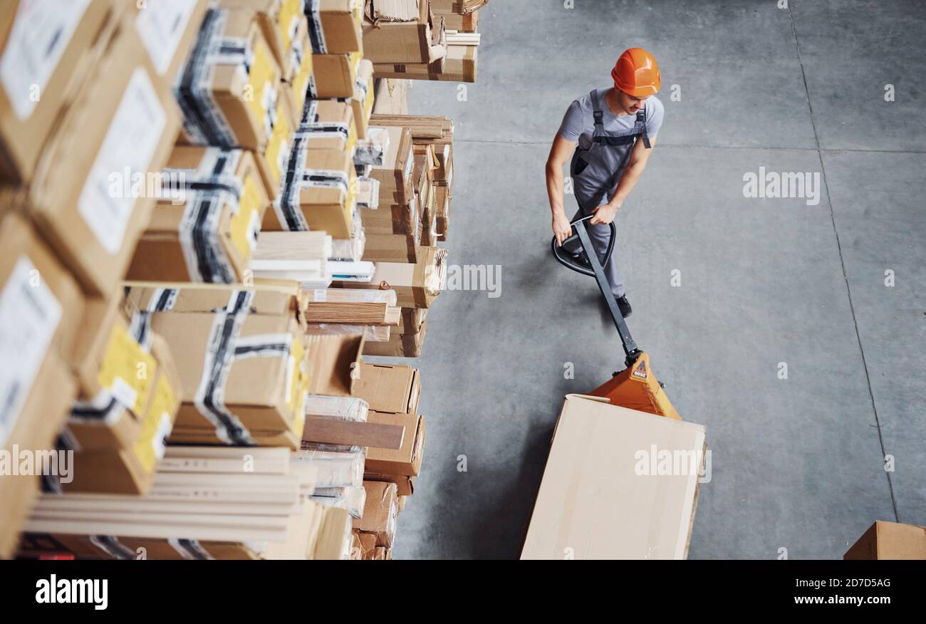 Top view of male worker in warehouse with pallet truck Stock Photo - Alamy