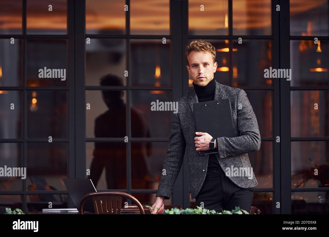 Man in elegant formal wear outside against modern building Stock Photo ...