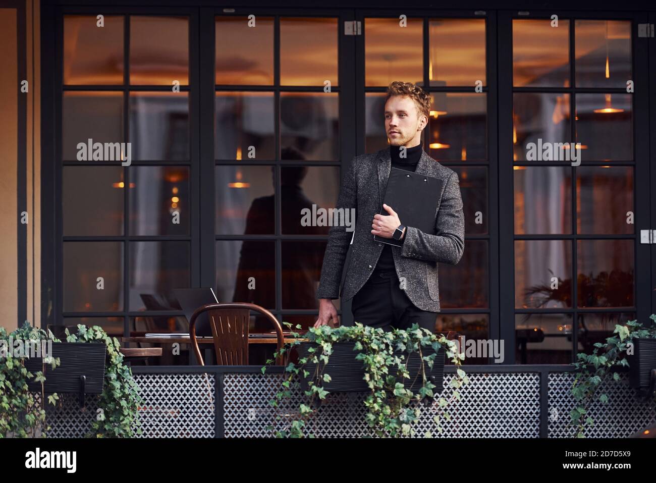 Man in elegant formal wear outside against modern building Stock Photo ...