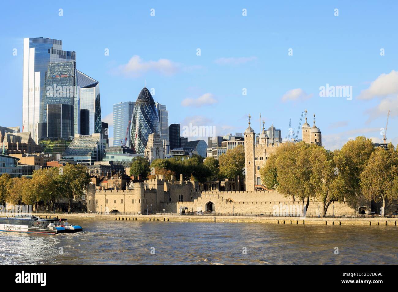 River Thames, London, 2020. Skyline of City of London with an UBER boat ...