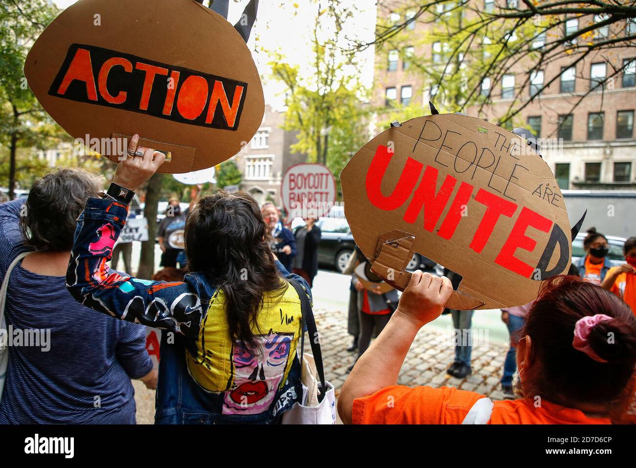 Protesters hold placards in front of Senator Chuck Schumer during the ...