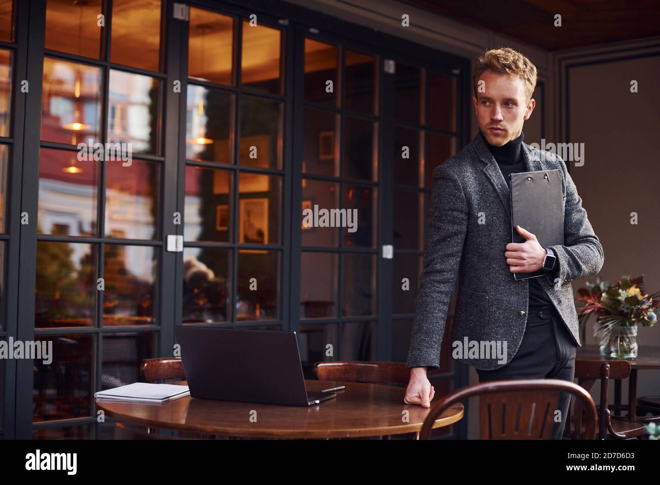 Man in elegant formal wear outside against modern building Stock Photo ...