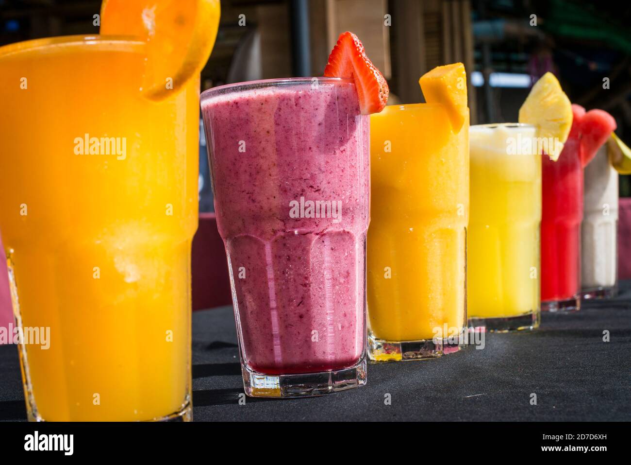 A selection of Fruit shakes displayed together in formation on a table ...