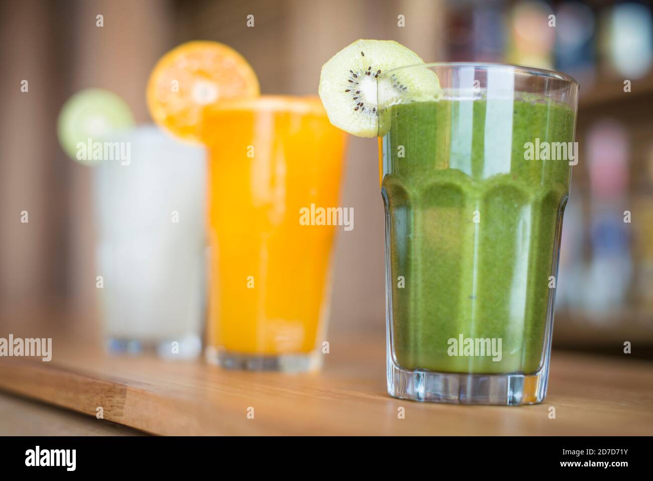 A selection of Fruit shakes displayed together in formation on a table ...