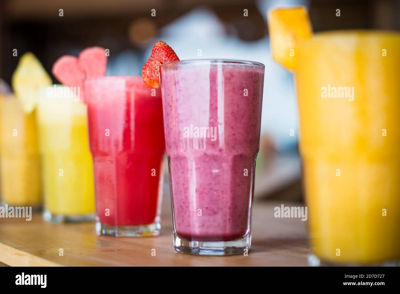 A selection of Fruit shakes displayed together in formation on a table ...