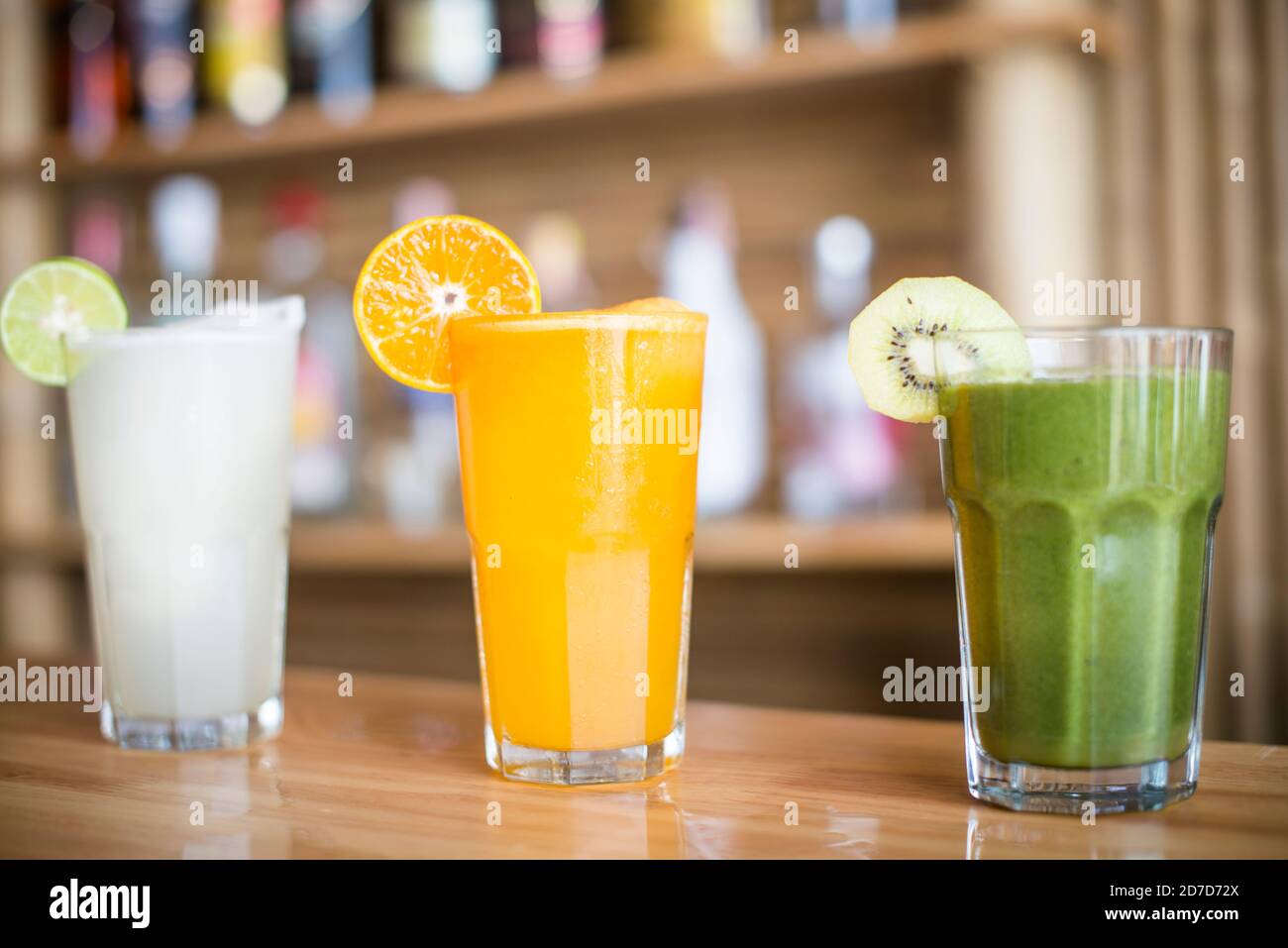 A selection of Fruit shakes displayed together in formation on a table ...