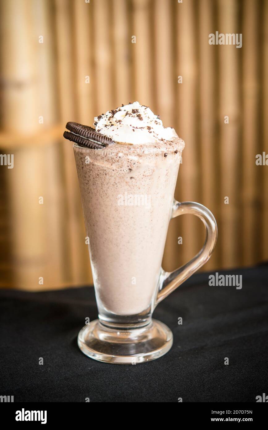 Iced coffee milkshake on a woodon table with a wood background Stock ...