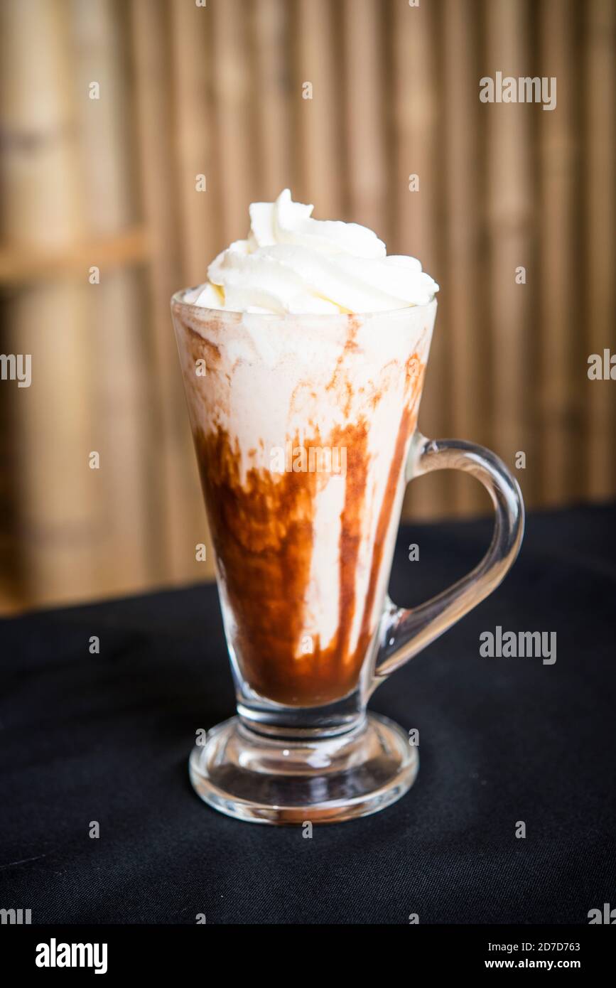 Iced coffee milkshake on a woodon table with a wood background Stock ...