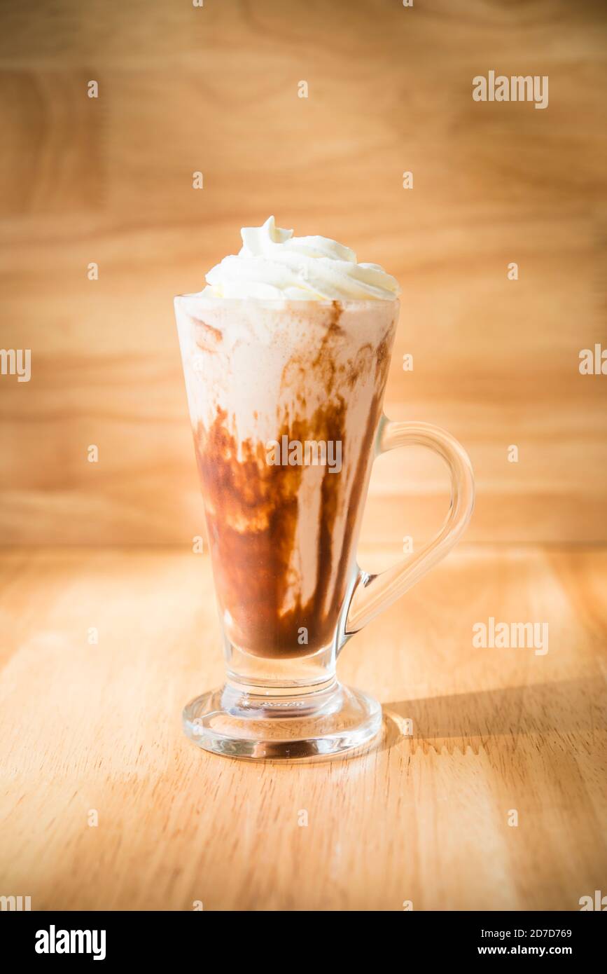 Iced coffee milkshake on a woodon table with a wood background Stock ...