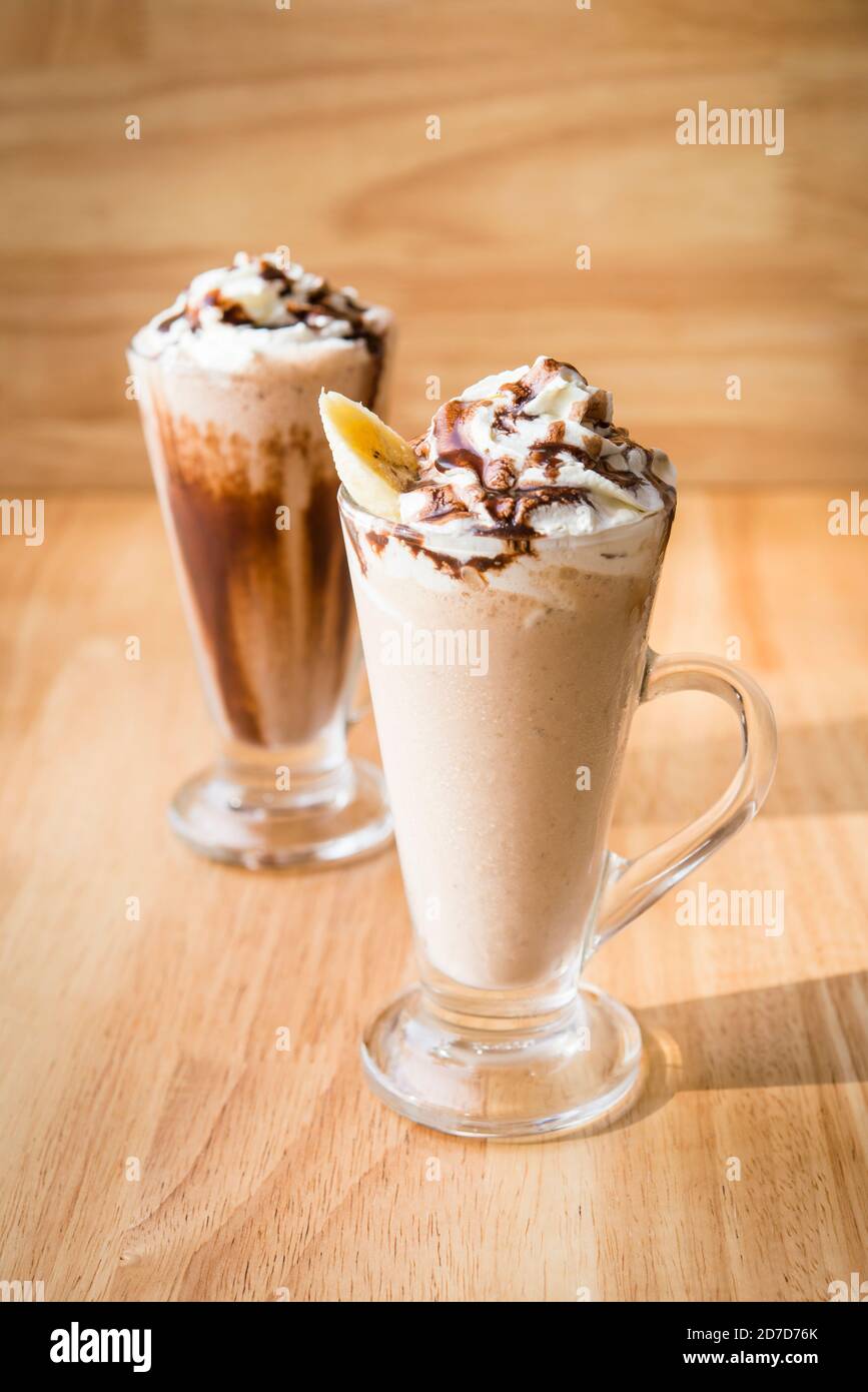 Iced coffee milkshake on a woodon table with a wood background Stock ...