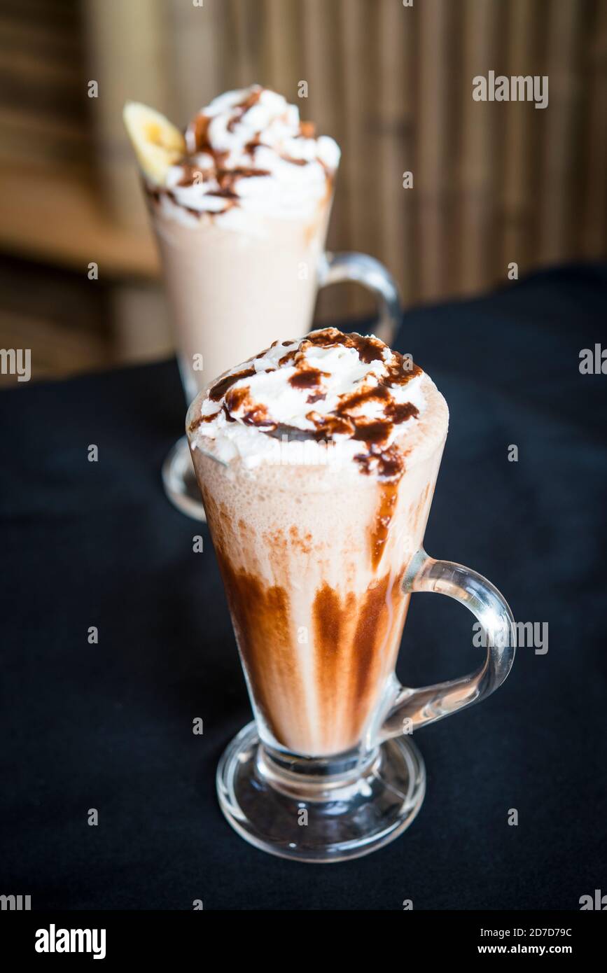 Iced coffee milkshake on a woodon table with a wood background Stock ...