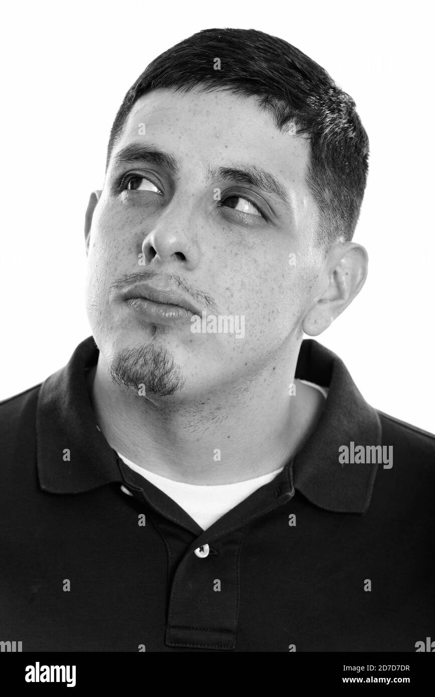 Face of young Hispanic man thinking while looking up Stock Photo - Alamy