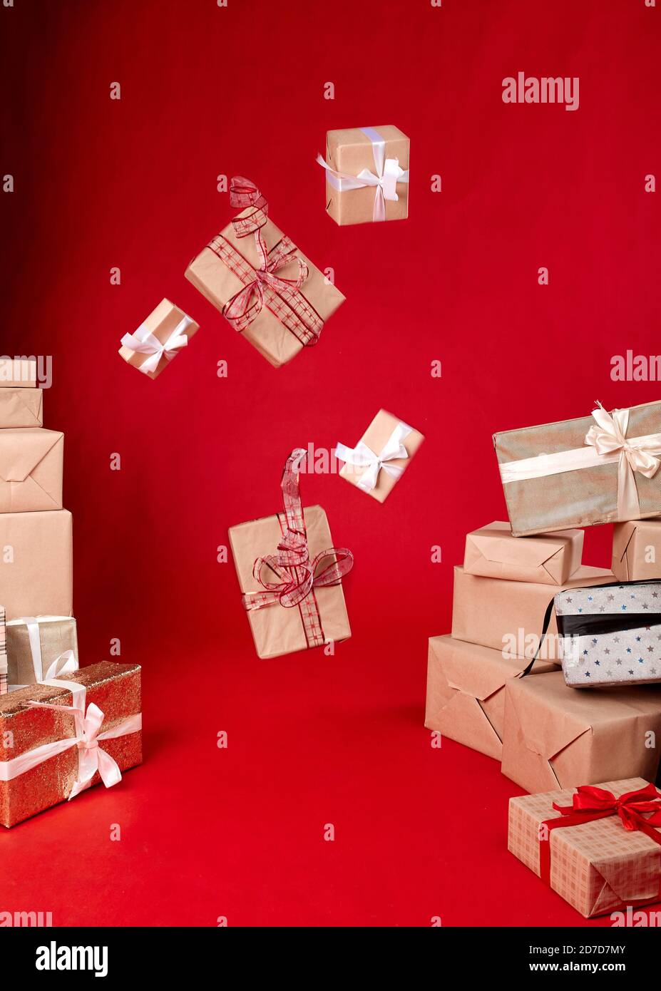gifts in the air on a red background Stock Photo - Alamy