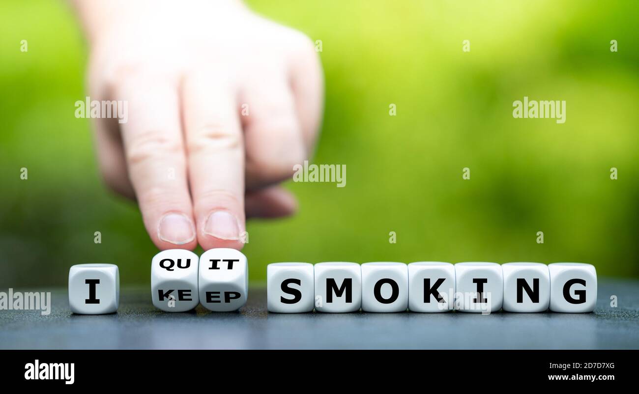 Hand turns dice and changes the expression "I keep smoking" to "I quit ...