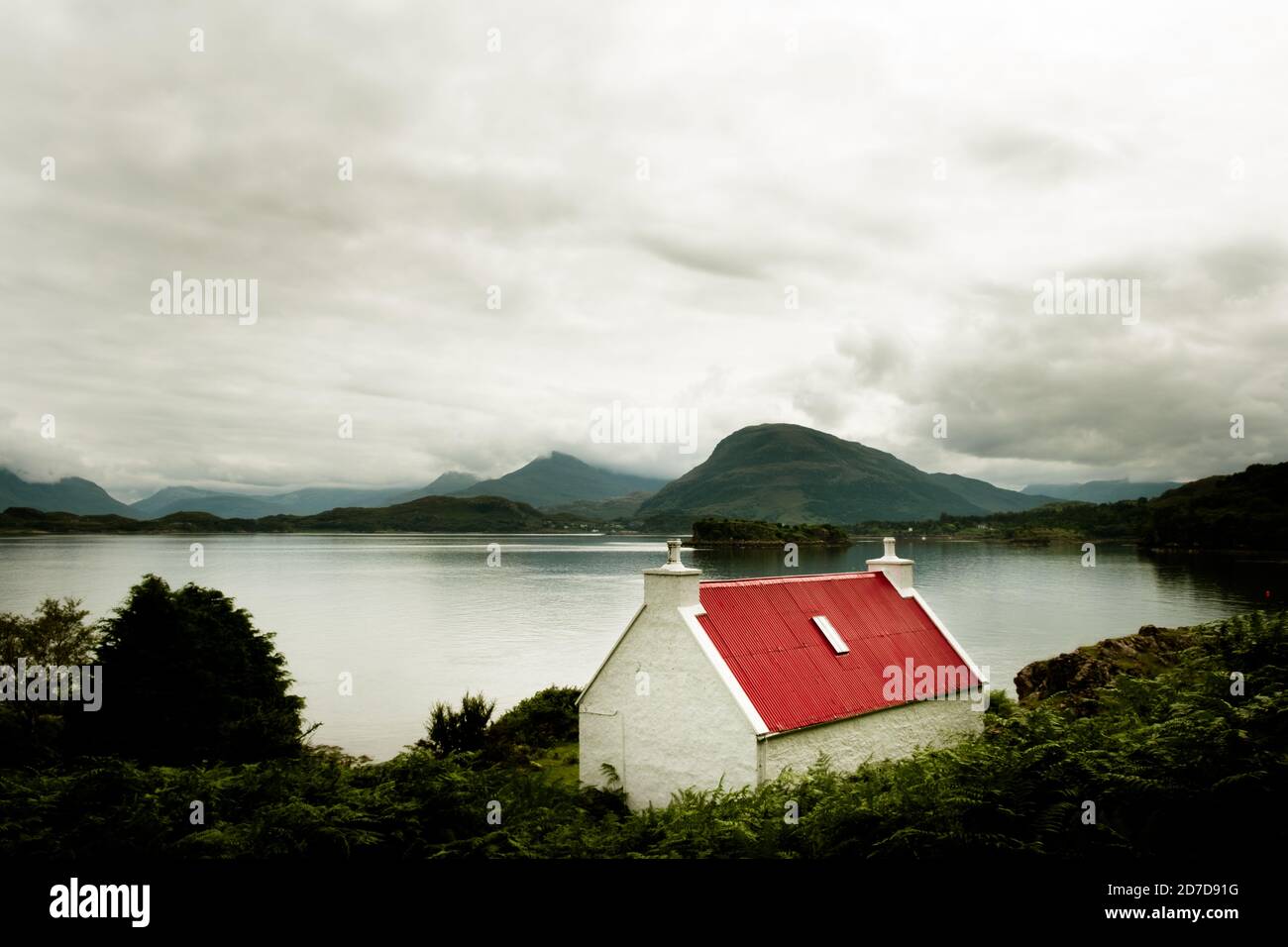 Loch Torridon with white cottage with red roof Stock Photo - Alamy