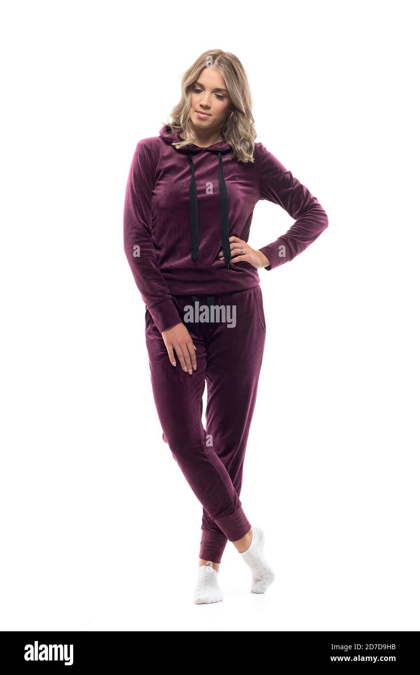 Longing thoughtful woman in maroon tracksuit home wear looking down ...