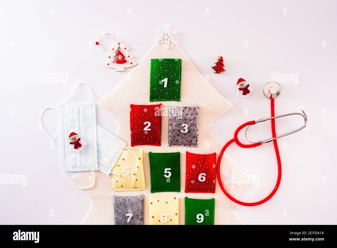 Traditional advent calendar protected with medical face masks, isolated ...