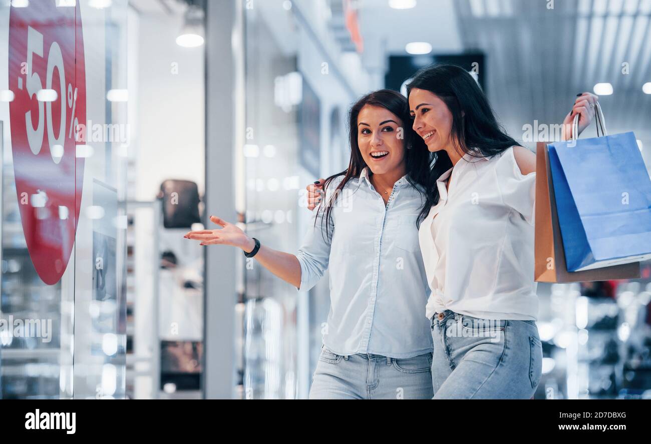 Feeling excited. Two young women have a shopping day together in the ...