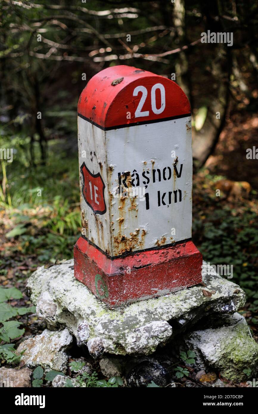 Old and worn out road sign indicating 1 km until the Romanian town of ...