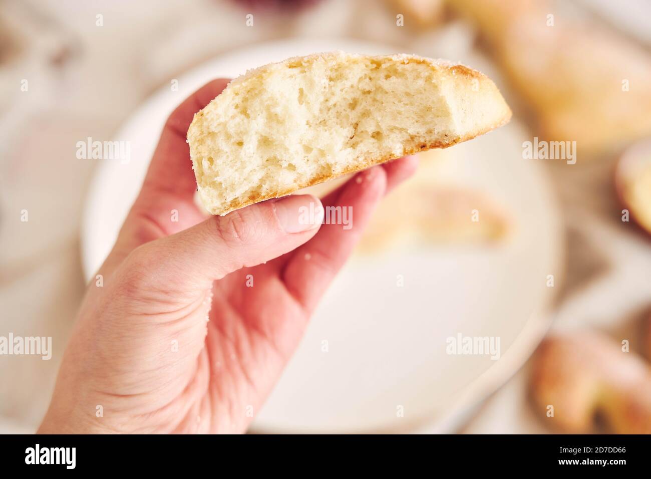 Hand holding a bitten biscuit Stock Photo - Alamy