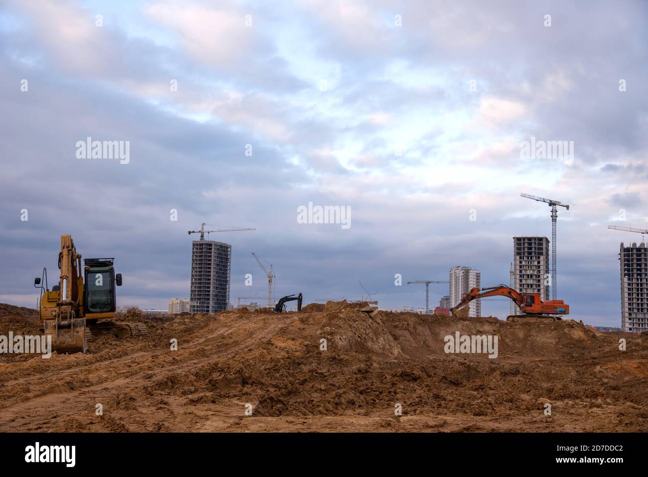 Group of the excavators for dig ground trenching at a construction site ...