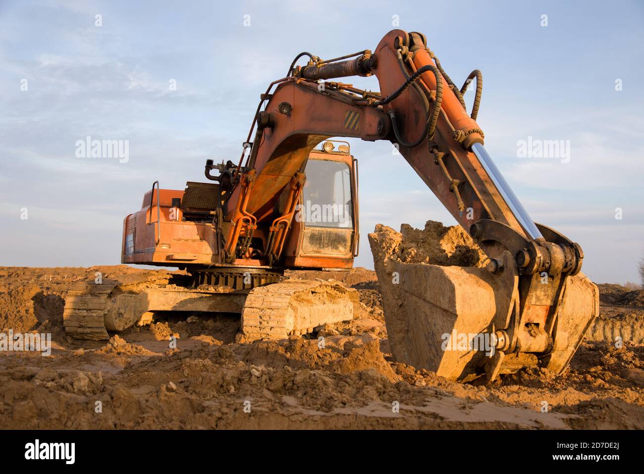 Track-type excavator during earthmoving work at open-pit mining. Loader ...