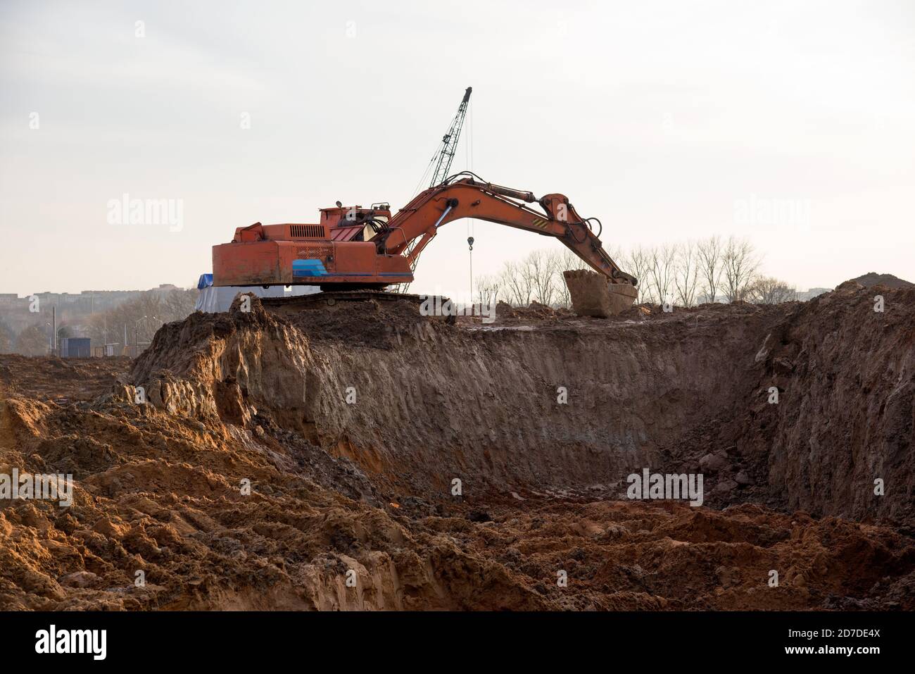 Large excavator working at construction site. Backhoe during earthworks ...