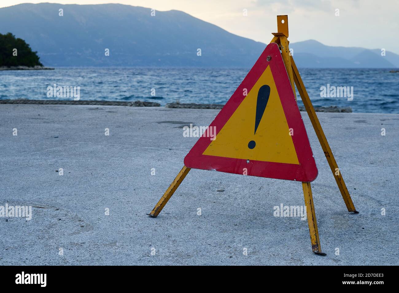 warning sign in the docking bay with sea and clouds in the beackground ...