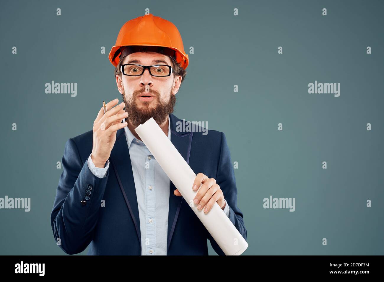 Male engineer wearing a suit in orange paint safety work drawings Stock ...