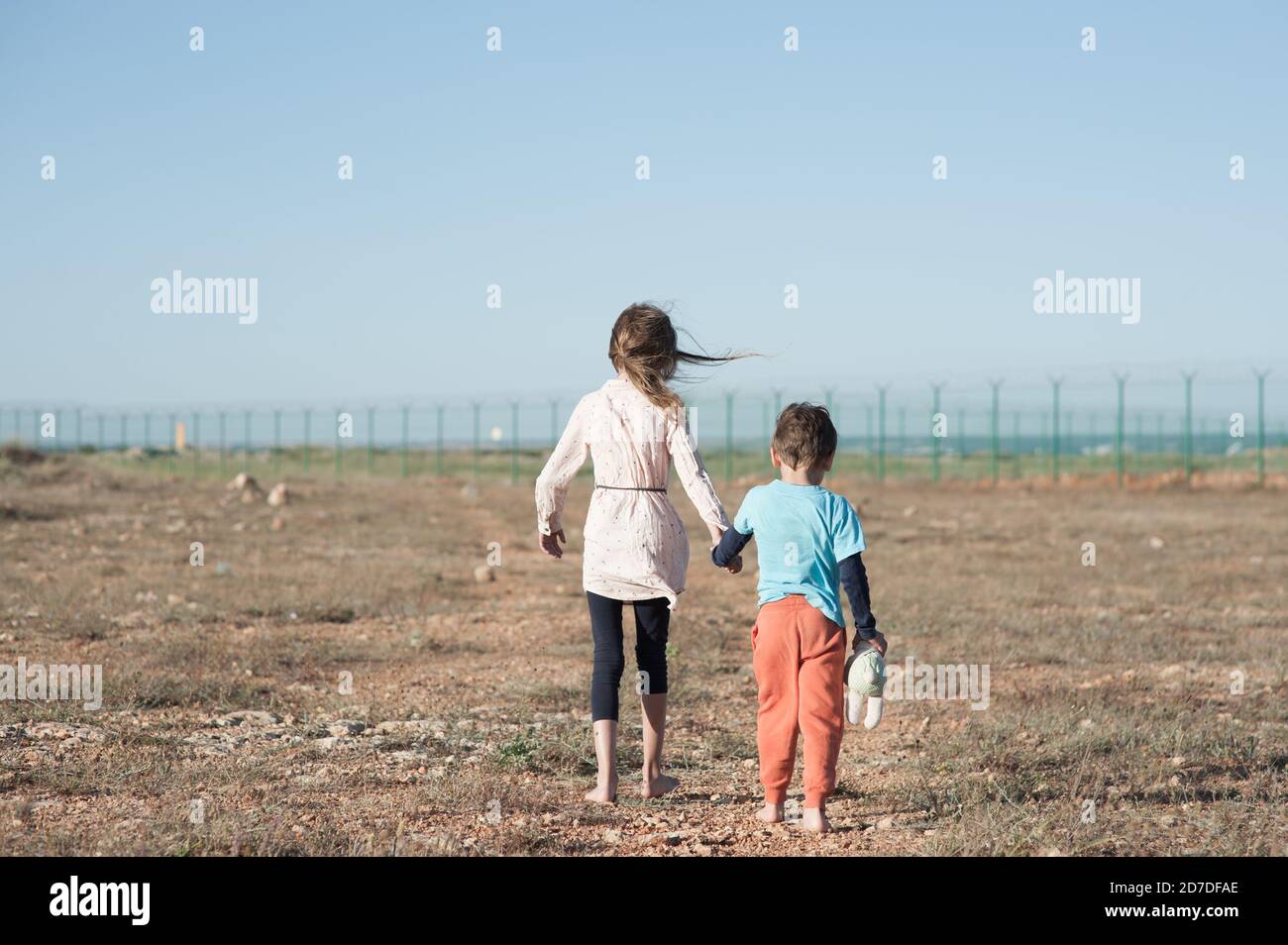 two poor kids family brother with toy and thin sister refugee illegal ...