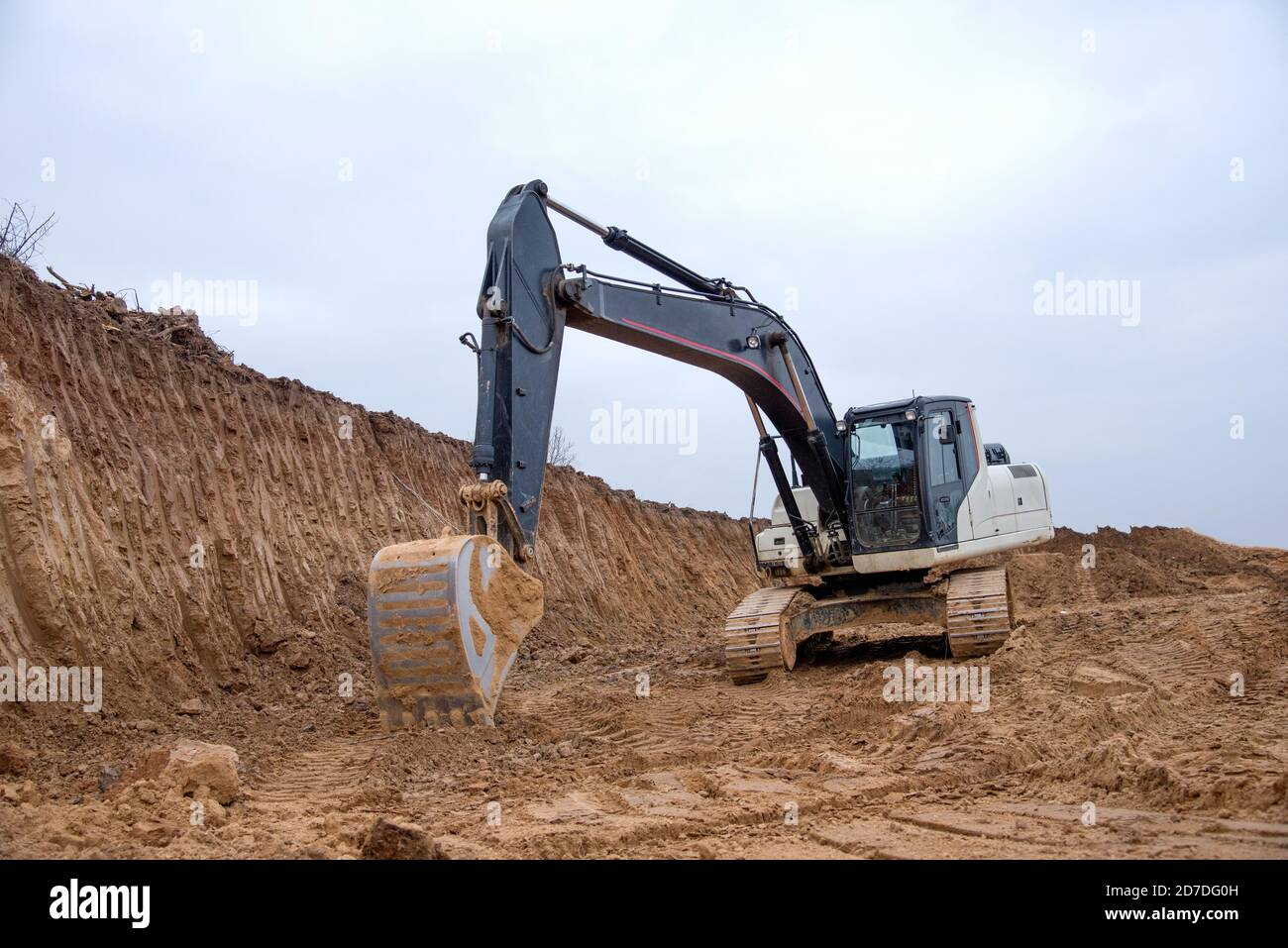 Excavator during earthworks at construction site. Backhoe digging the ...
