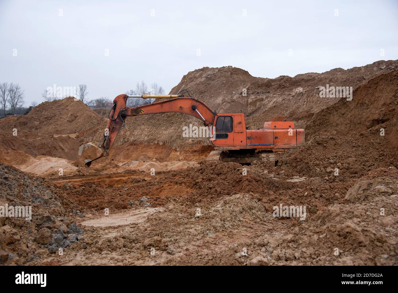 Excavator during earthworks at construction site. Backhoe digging the ...