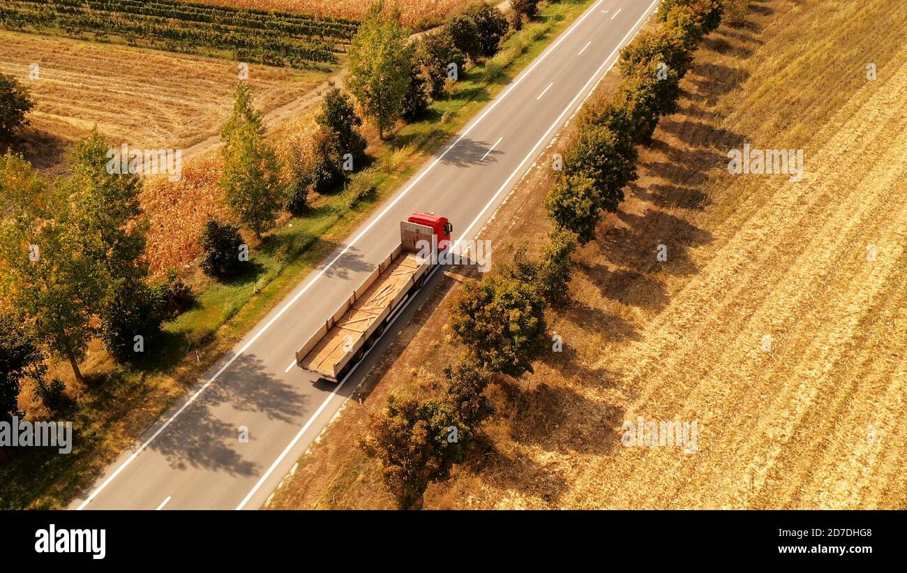 Truck on the road through countryside, aerial view of freight ...