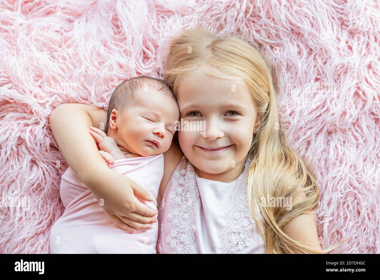 Little girl and her newborn sister. Toddler kid meeting new sibling ...