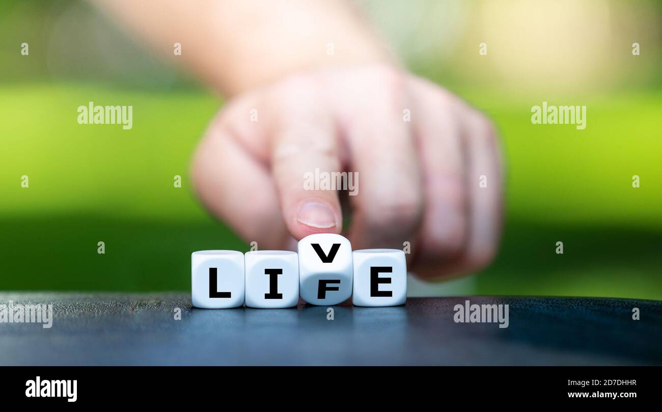 Live your life. Hand turns a dice and changes the word "LIVE" to "LIFE ...