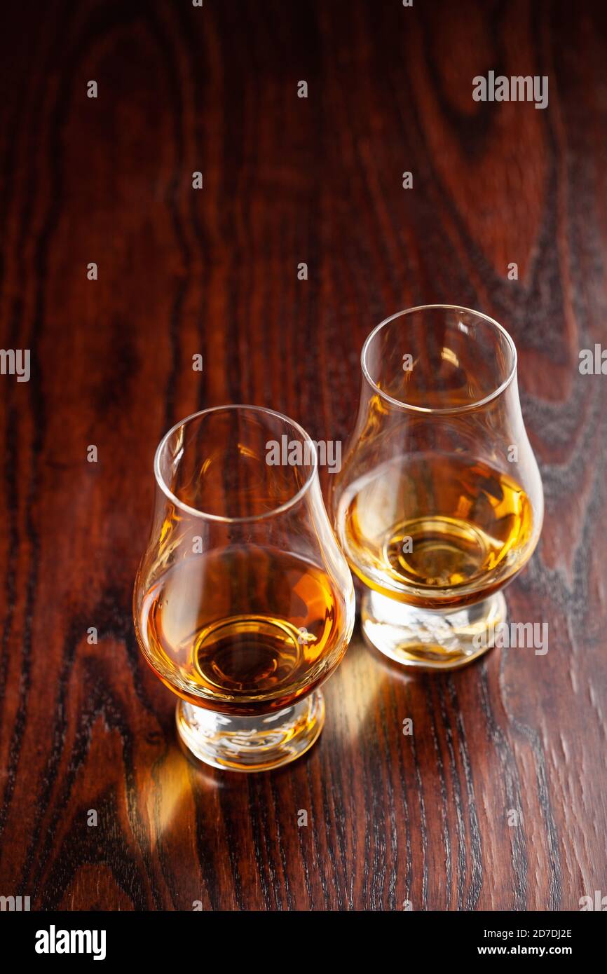 glass of whisky spirit brandy on dark brown background Stock Photo - Alamy