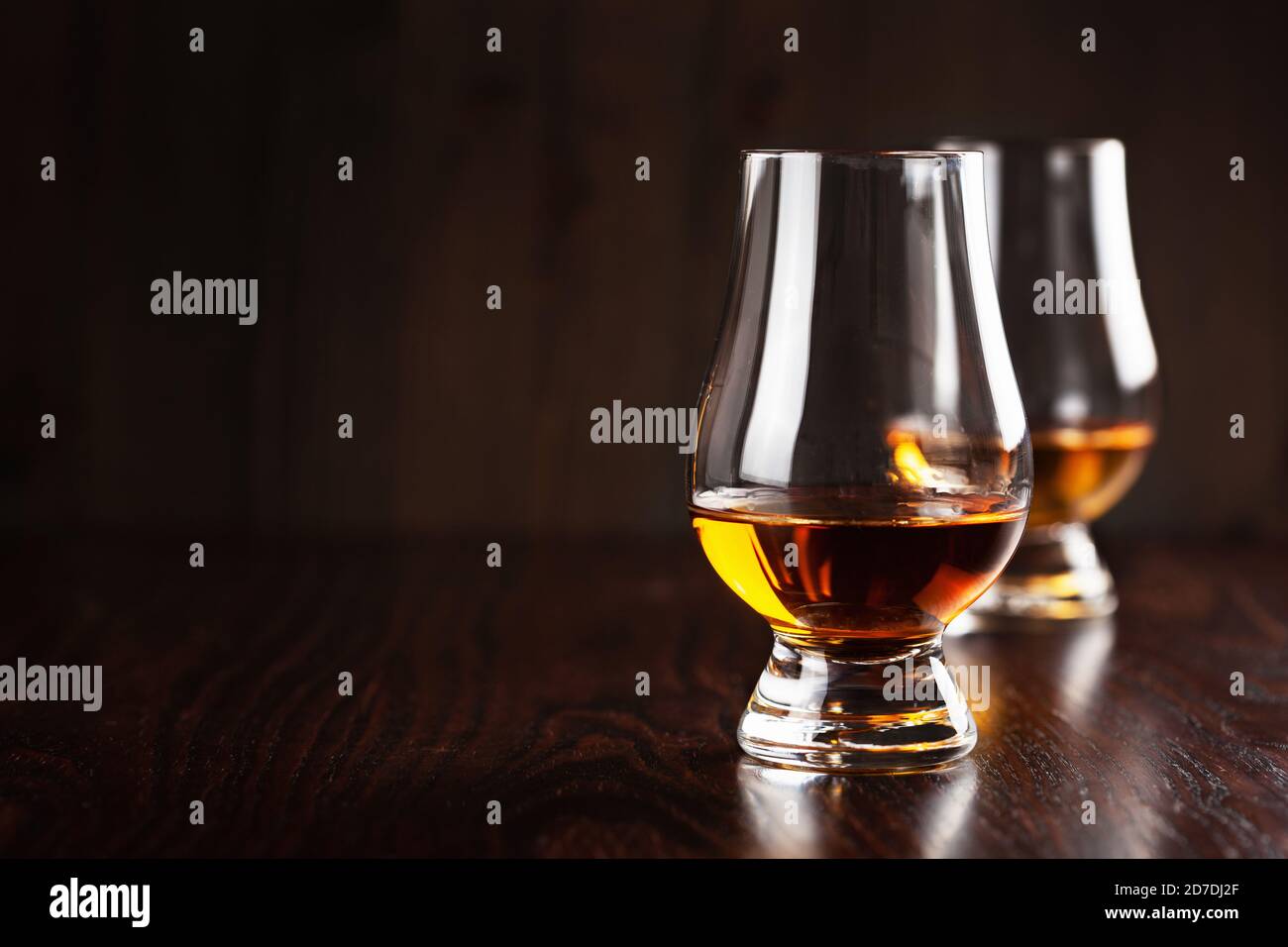 glass of whisky spirit brandy on dark brown background Stock Photo - Alamy
