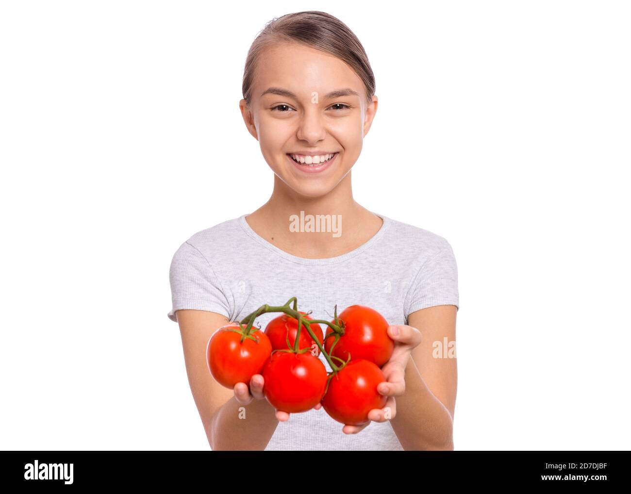 Beautiful young teen girl holding fresh tomatoes, isolated on white ...