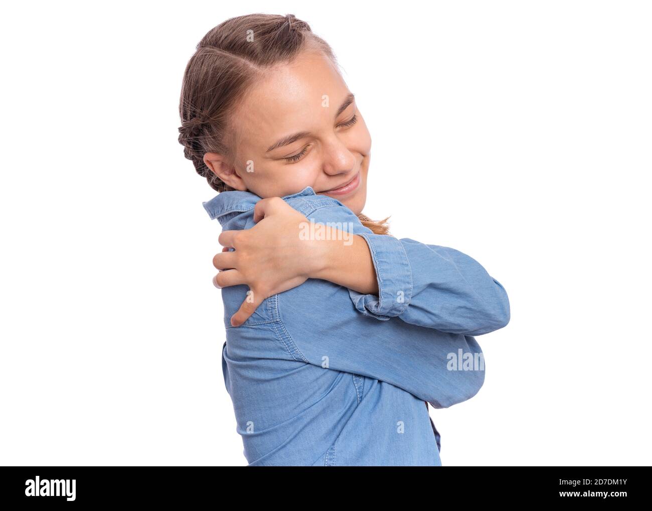 Portrait of calm cheerful teenage girl hug herself, isolated on white ...