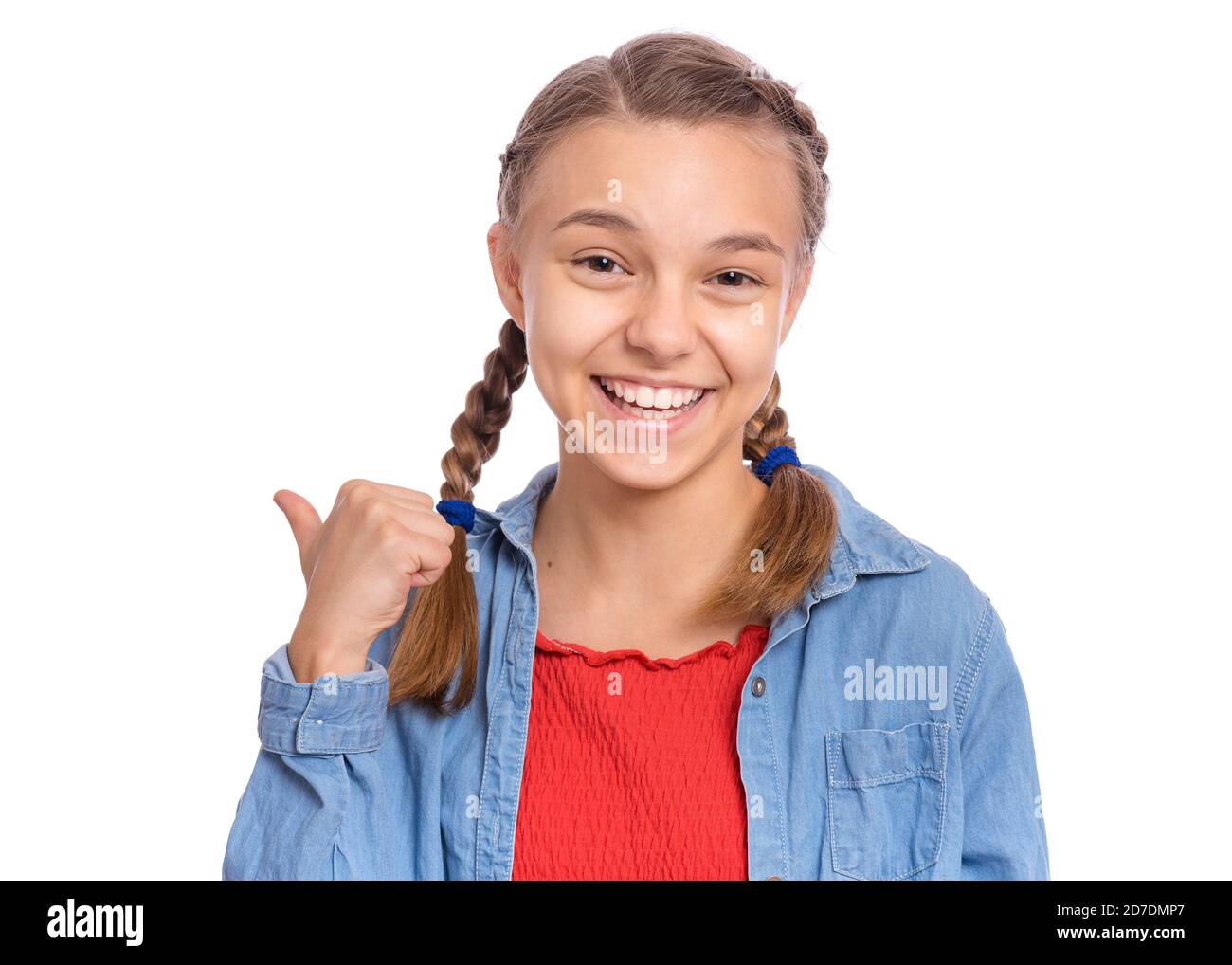 Happy teenage girl pointing up, gesturing idea or doing number one ...