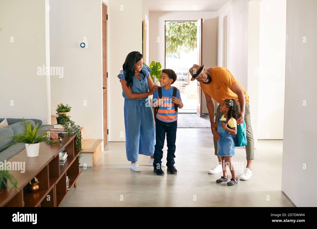 Parents Saying Goodbye To Children As They Leave Home For School Stock ...