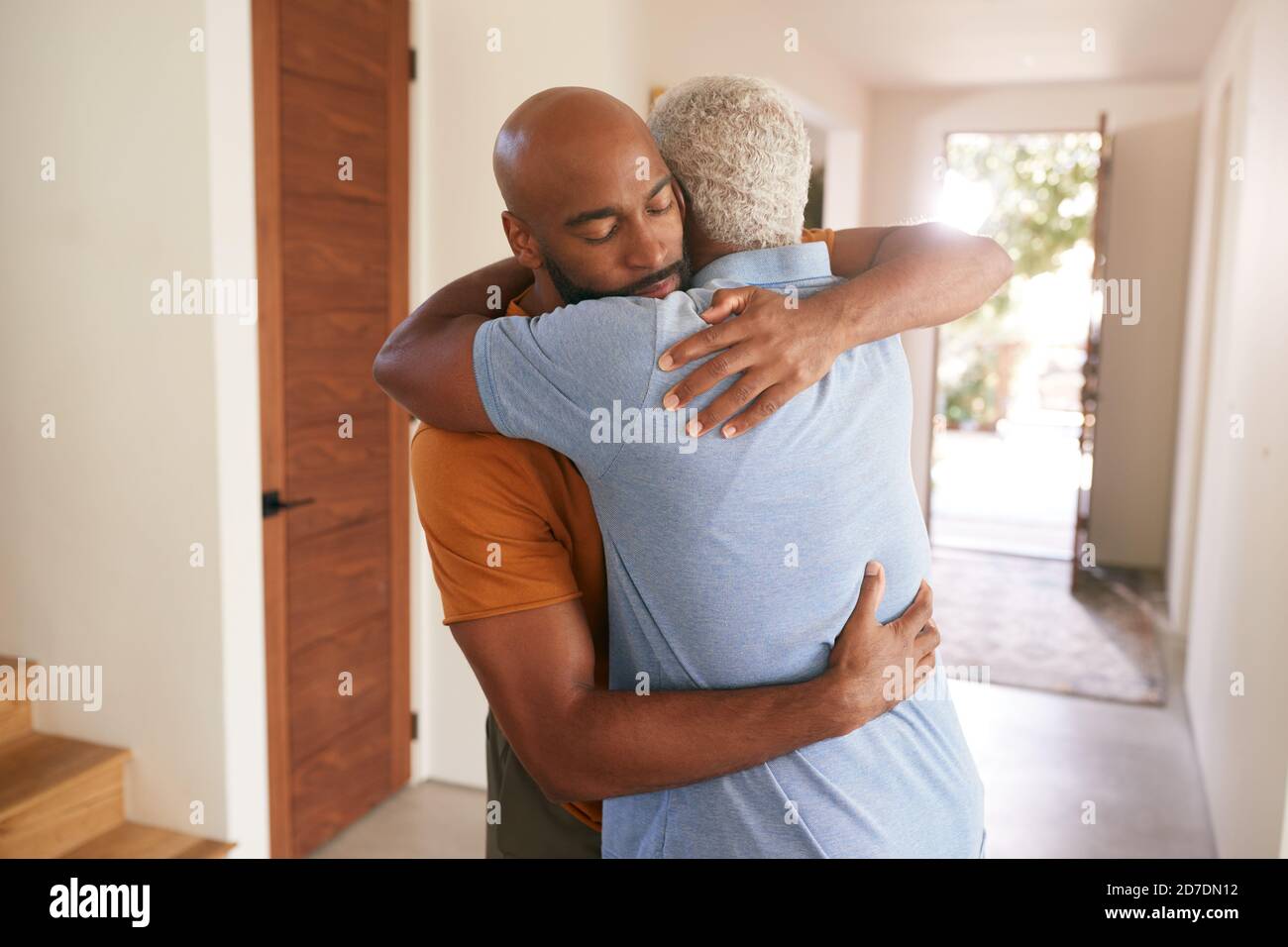Loving Senior Father Hugging Adult Son Indoors At Home Stock Photo - Alamy
