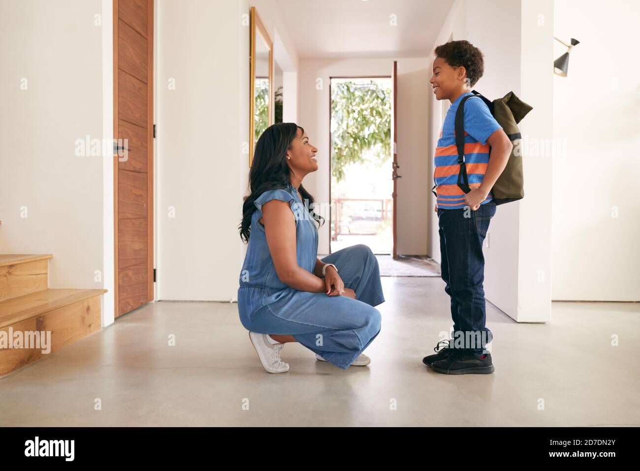Mother Saying Goodbye To Son As He Leaves Home For School Stock Photo ...