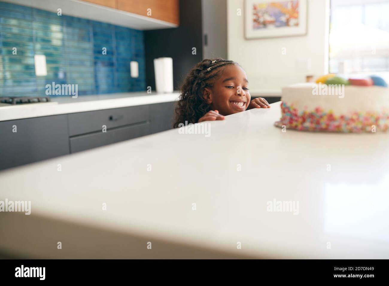 Girl Hiding Behind Kitchen Counter Takes Sneaky Look At Birthday Cake ...