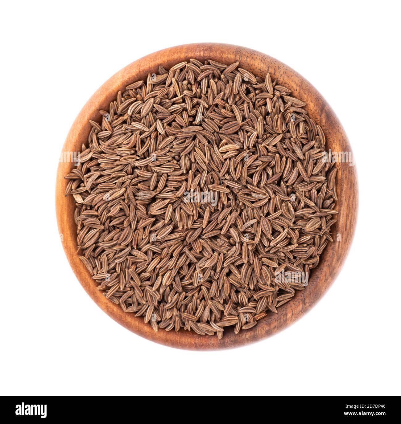 Cumin seeds in wooden bowl, isolated on white background. Cumin seeds ...
